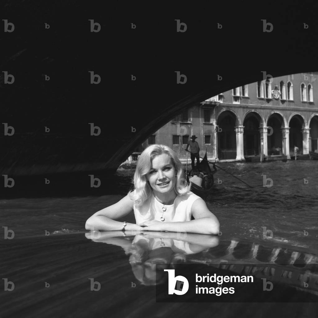 Image of American actress Carroll Baker, wearing a white dress ...