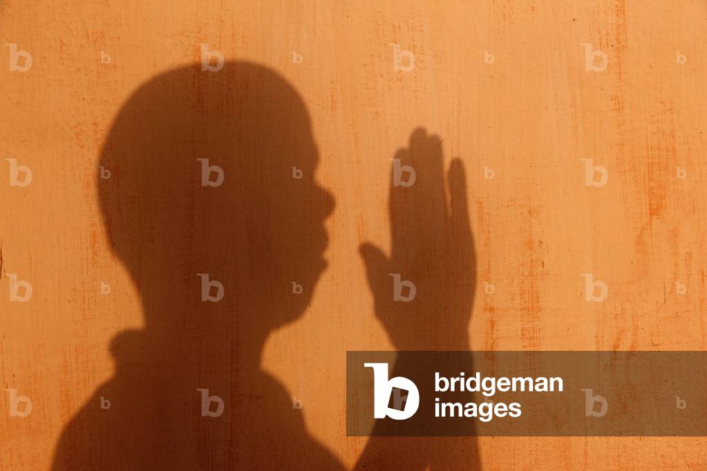Image of Shadow of a praying man, Lome, Togo