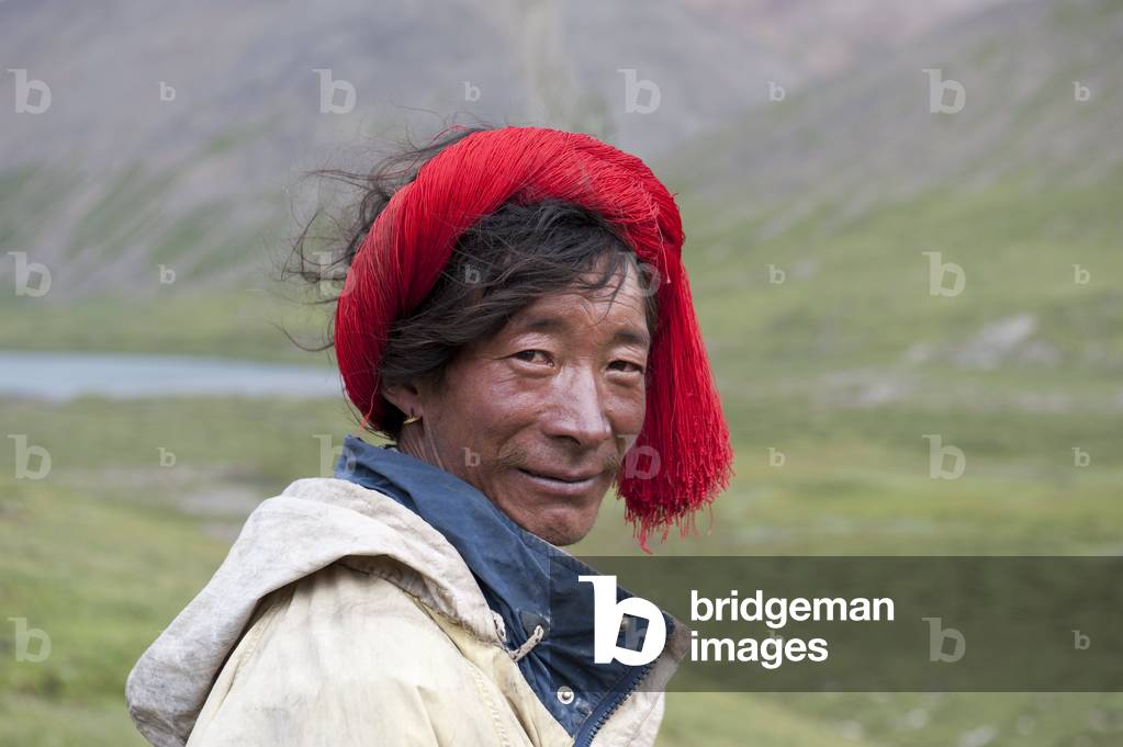 Image of Tibetan wearing traditional red hair accessories; portrait ...