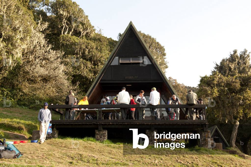 Image of Trekking; tourists relaxing; wooden hut; Mandara Hut; Marangu ...