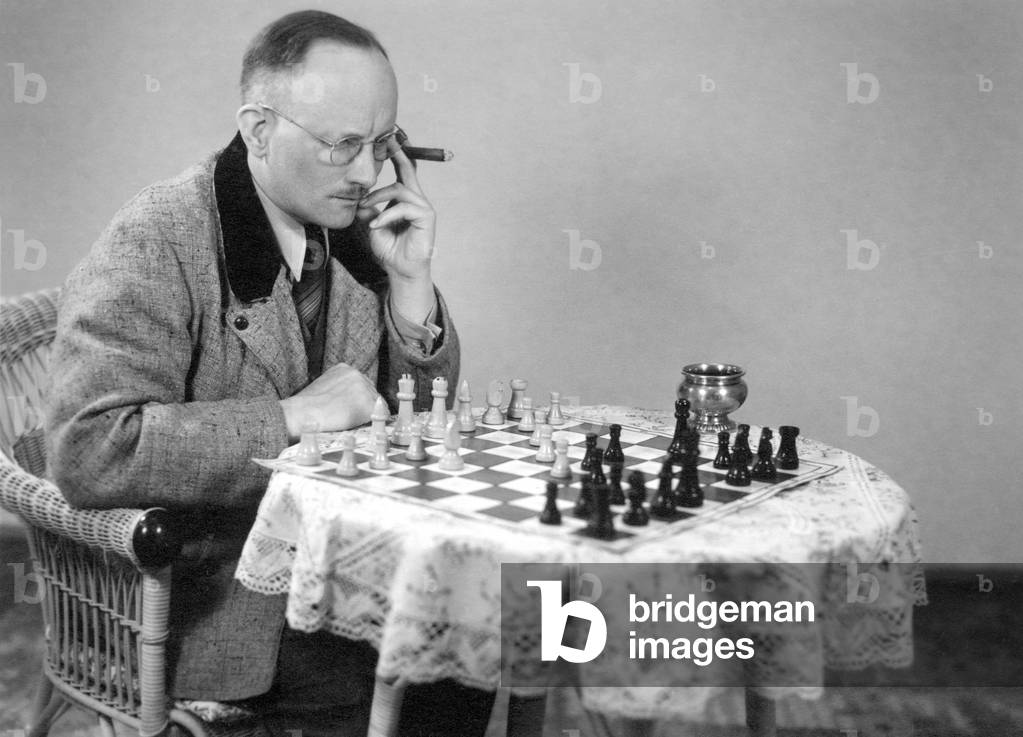 Image of Man playing solo chess. Photography around 1930.