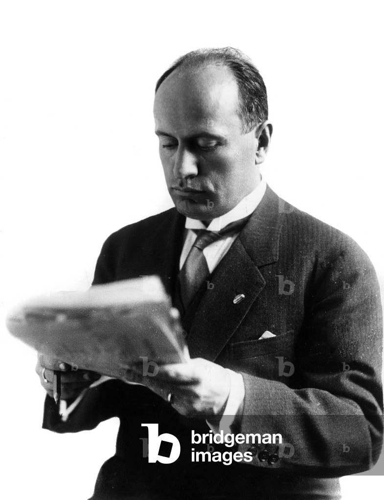 Image of Benito Mussolini reading a newspaper. 1920s (b/w photo)
