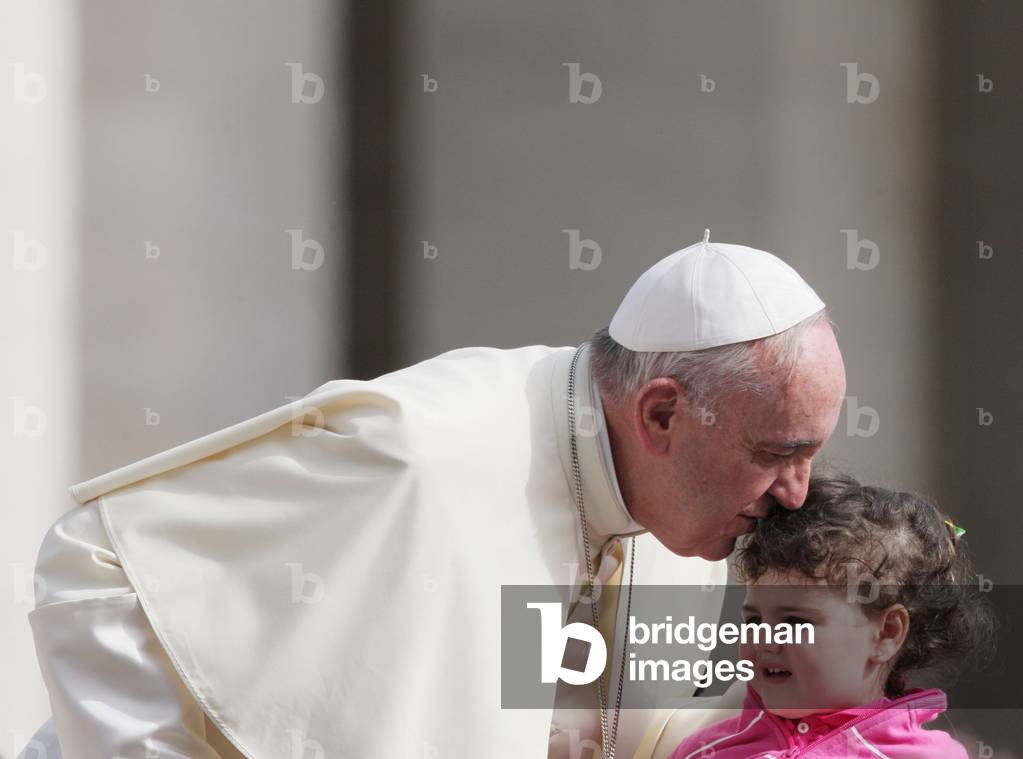 Image of Pope Francis (Jorge Mario Bergoglio) kissing a child during the