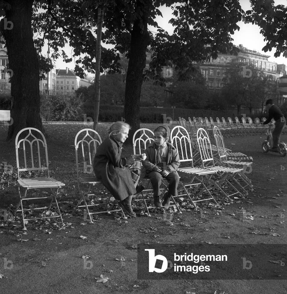 Image of Two Austrian children sitting in front of the Votive Church