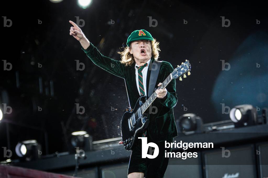 Image of Angus Young : Guitarist Angus Young during a concert of
