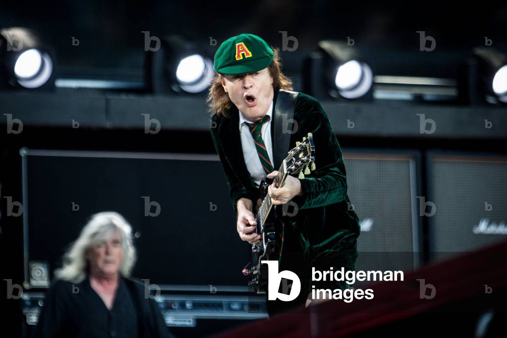 Image of Angus Young : Guitarist Angus Young during a concert of