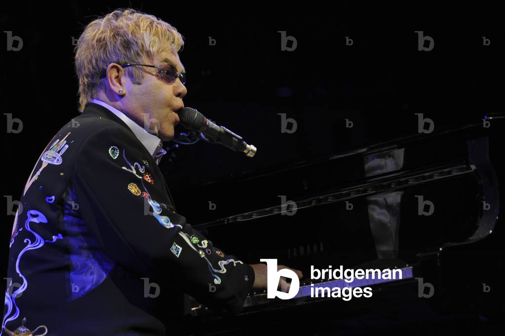 Image of The singer-songwriter Elton John performing with the musician ...