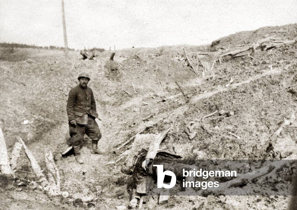 Image of A hairy man poses in front of a German corpse by French ...
