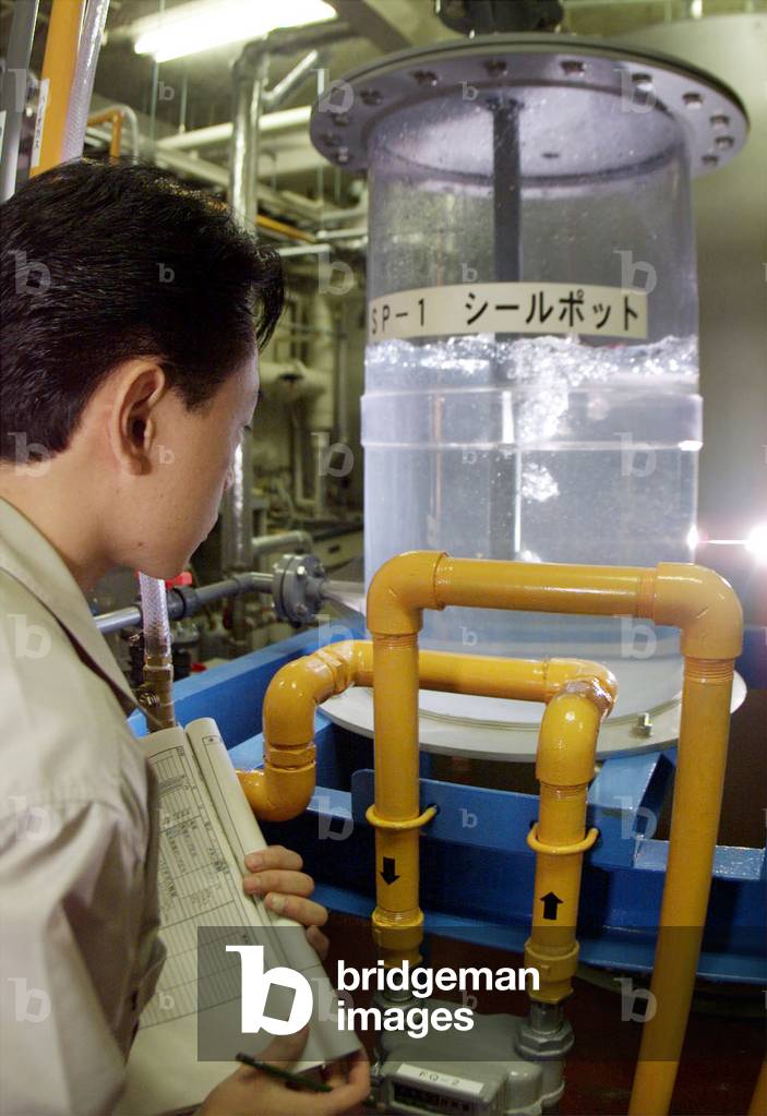 Image of A researcher checks a sealed pot of methane in the
