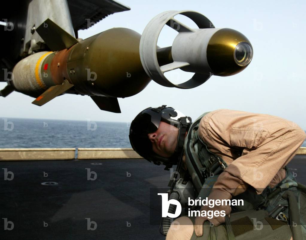 Image of AN F/A-18 HORNET PILOT CHECKS HIS LASER GUIDED BOMBS THE