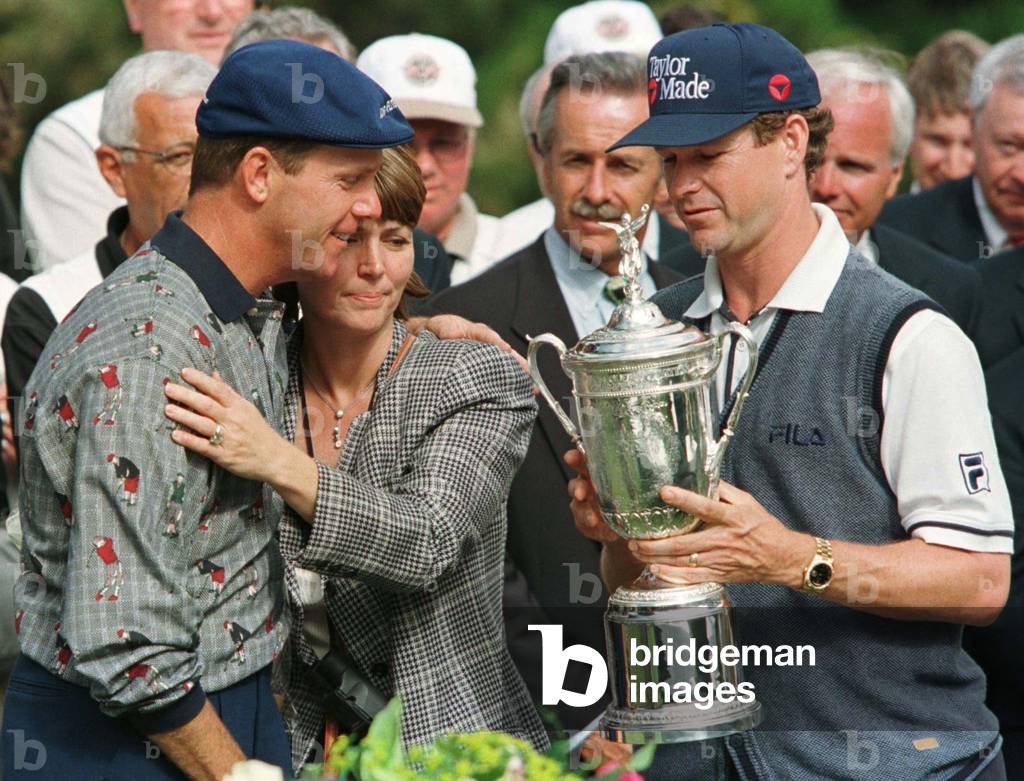 Image of Beverly Janzen (C) hugs Payne Stewart (L) as her husband