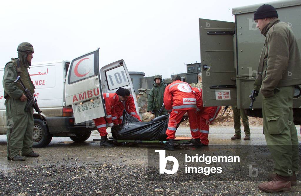 Image of A PALESTINIAN MEDICAL TEAM PUT THE BODY OF A GUNMAN