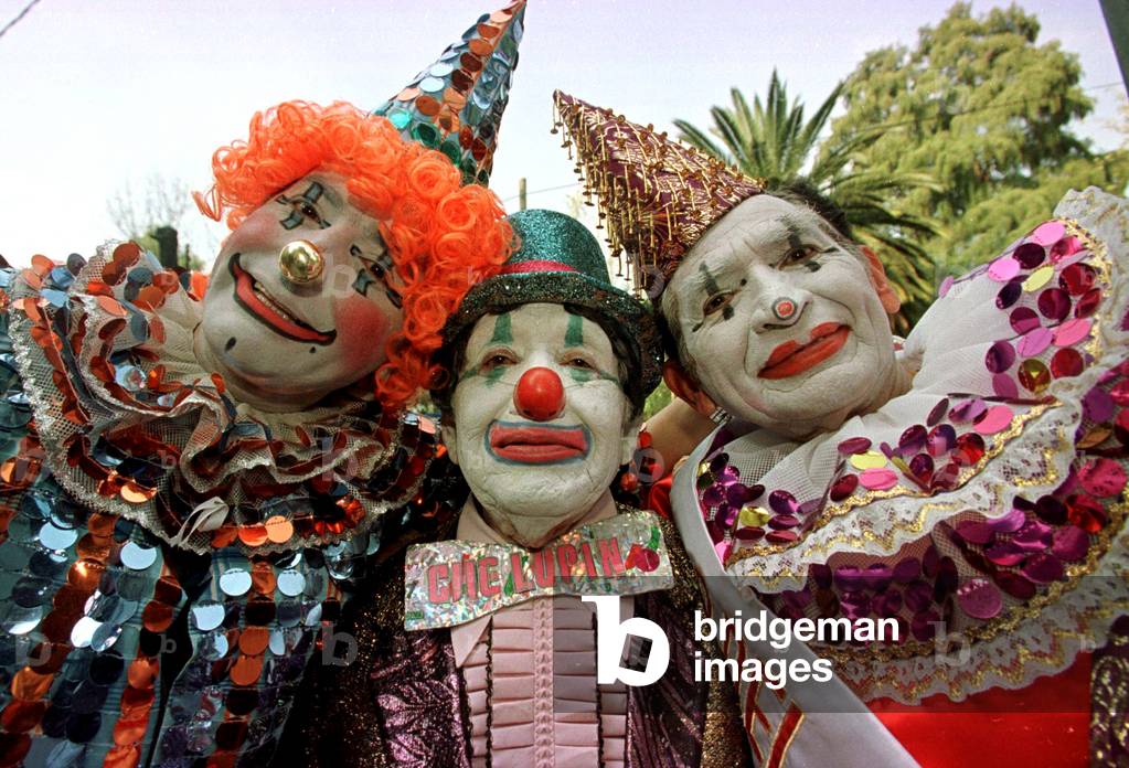 Image of Three Mexican clowns fool around in Mexico City on December