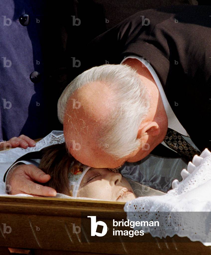 Image of Former Soviet leader Mikhail Gorbachev bends over the coffin of