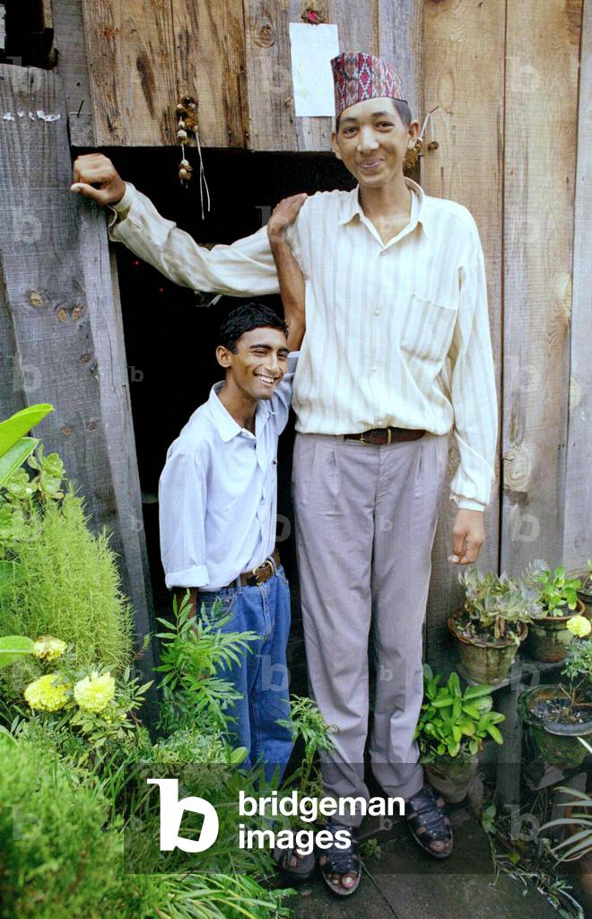 Image of Rajan Adhikari, 22 (R) poses next to his cousin, Kumar