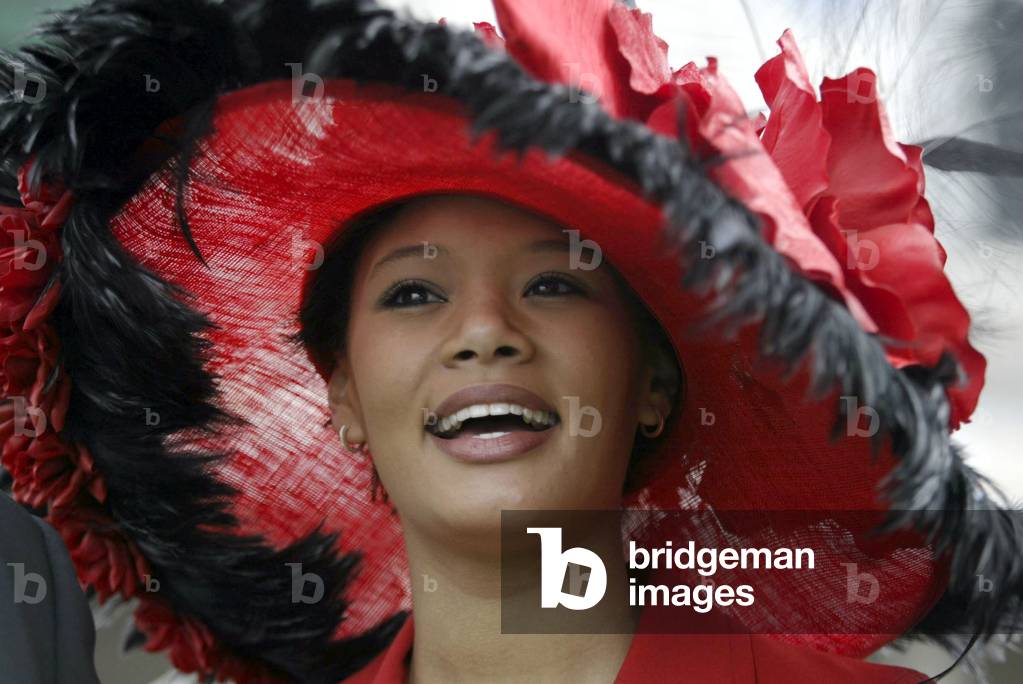 Image of Kentucky Derby fan Desiree McKenzie of Louisville laughs as she