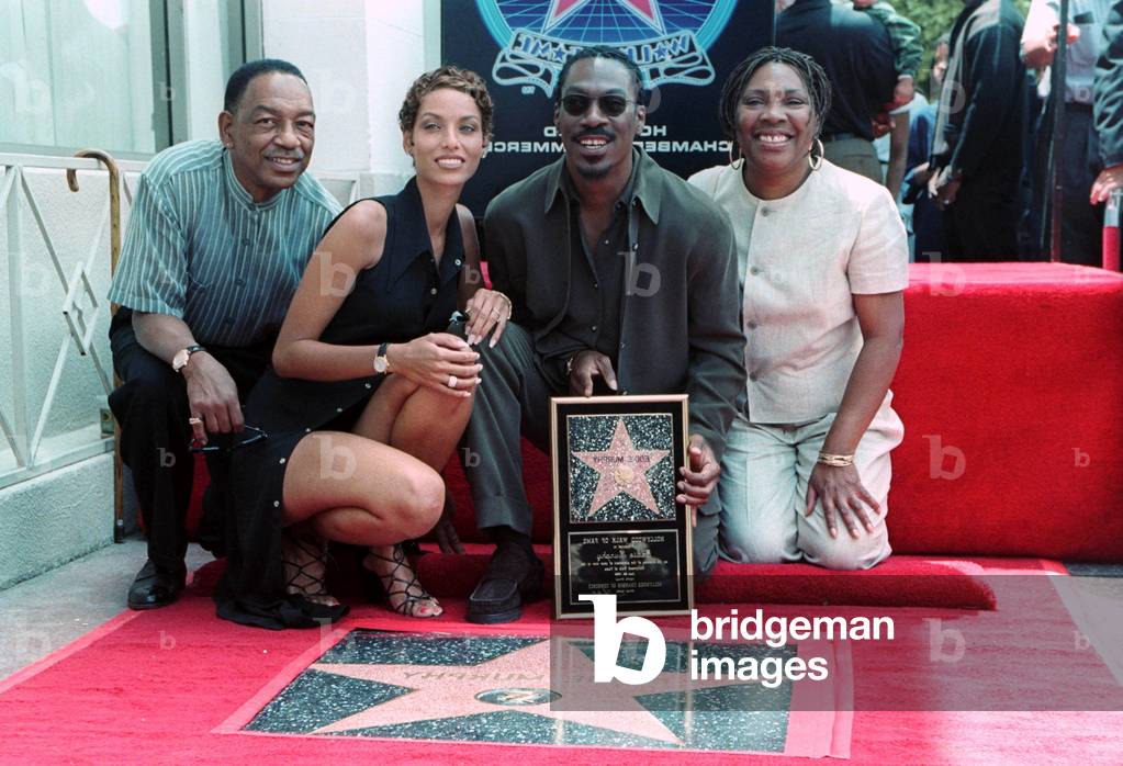Image of Eddie Murphy poses with his family as his star was