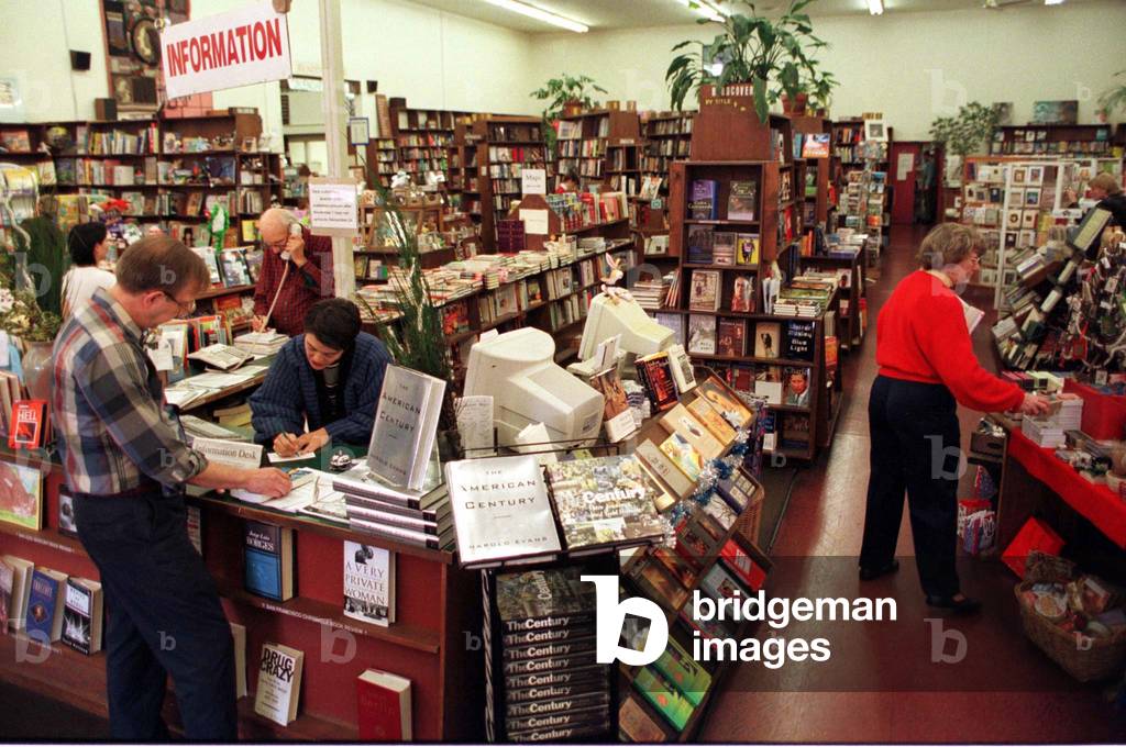 Image of A customer browses at right as another customer is helped