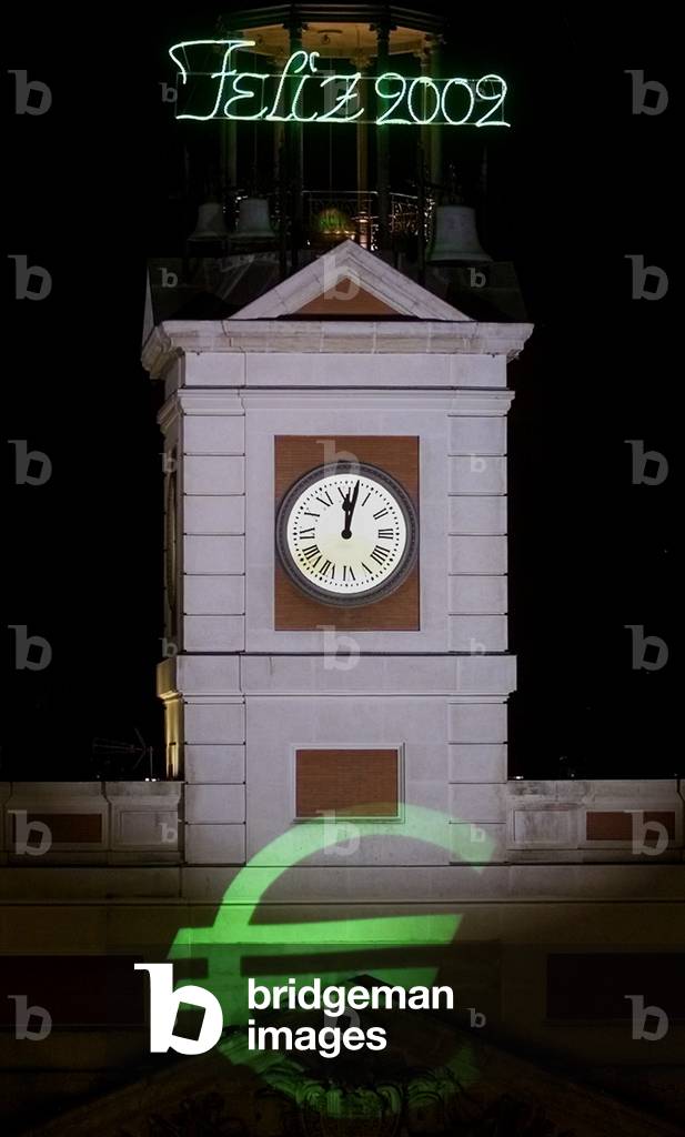 Image of EURO SYMBOL IS PROJECTED ONTO CLOCK OF MADRID'S CENTRAL PUERTA