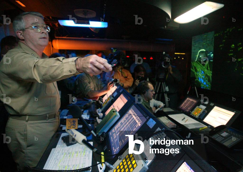 Image of REAR ADMIRAL KELLY EXPLAINS OPERATIONS ON BOARD THE USS ABRAHAM