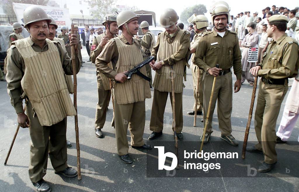 Image of INDIAN RIOT POLICE WATCH ANGRY DEMONSTRATORS AT DELHI NATIONAL ...