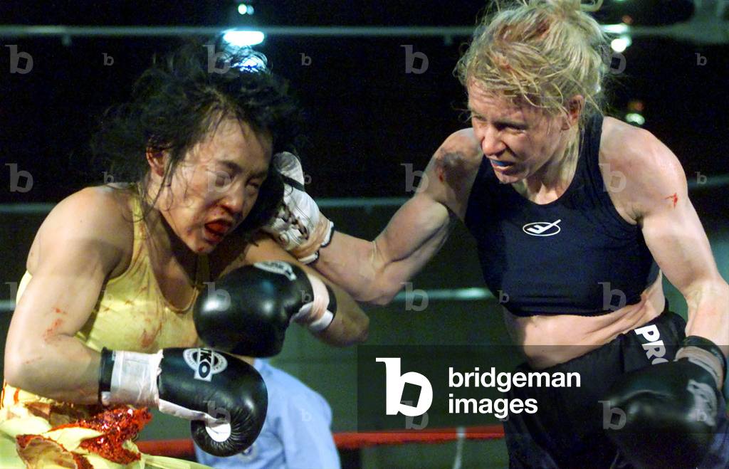 Image of British challenger Michelle Sutcliffelans (R) lands a punch to ...