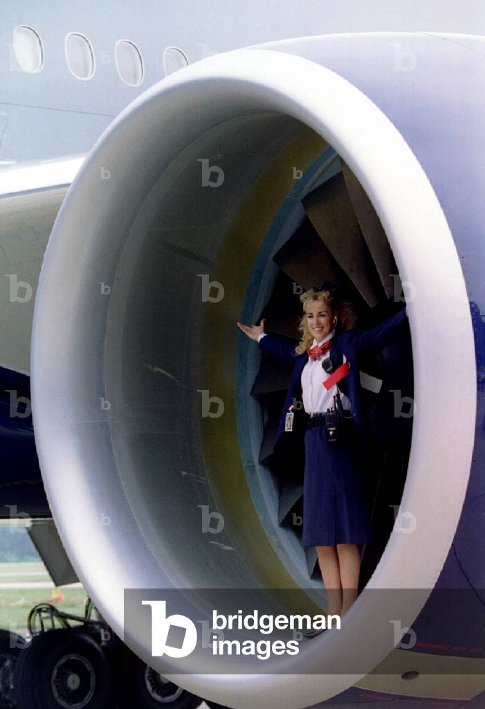 Image of An employee stands in the engine of United Airlines' new