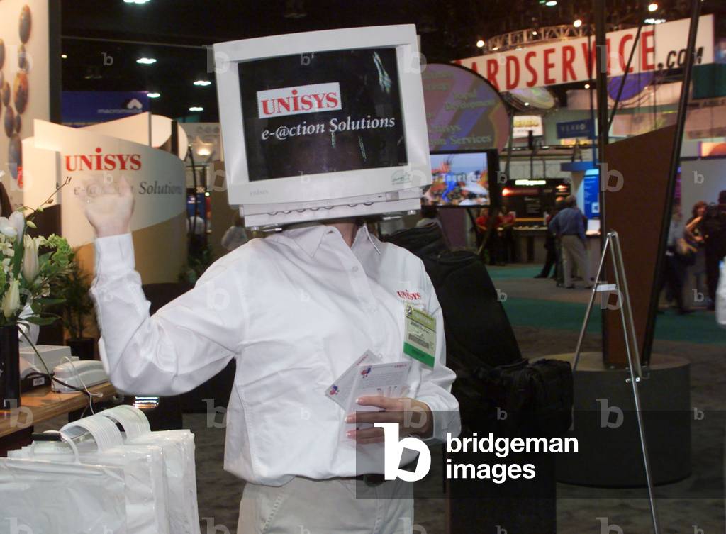 Image of A woman with a computer monitor over her head hands
