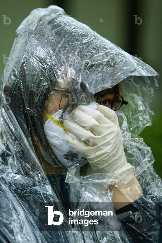 Image of VOLUNTEER IN MASK HELPS TO CLEAN HONG KONG'S NGAU TAU
