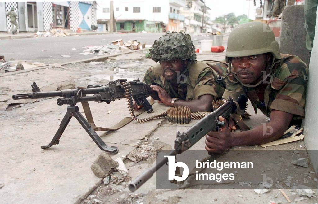 Image of Nigerian ECOMOG soldiers guard a corner in downtown Monrovia ...