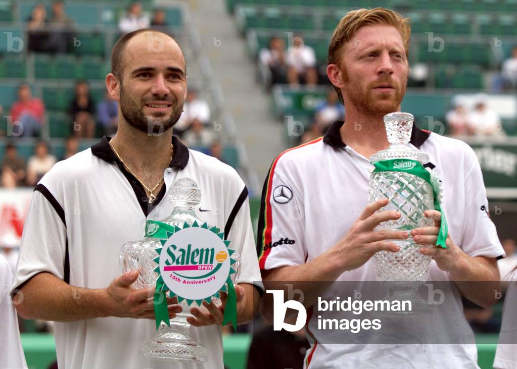 Image of ANDRE AGASSI IS AND BORIS BECKER HOLD TROPHIES AFTER ATP