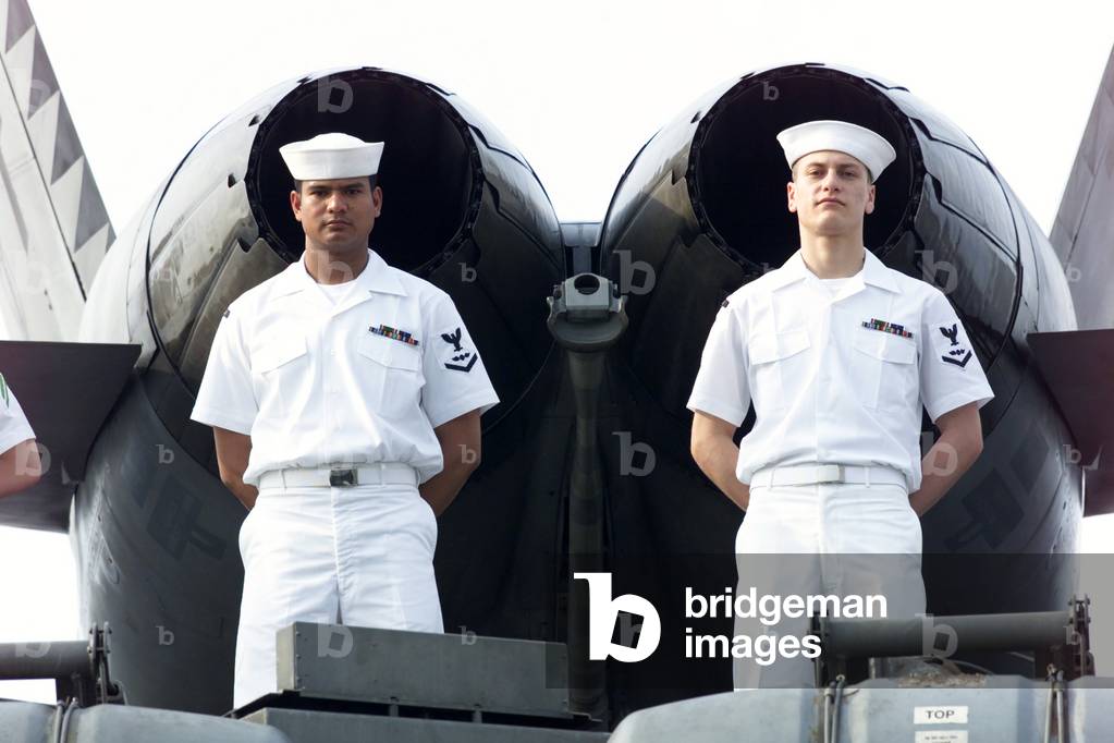 Image of US NAVY PERSONNEL STAND AT ATTENTION ABOARD THE AIRCRAFT CARRIER