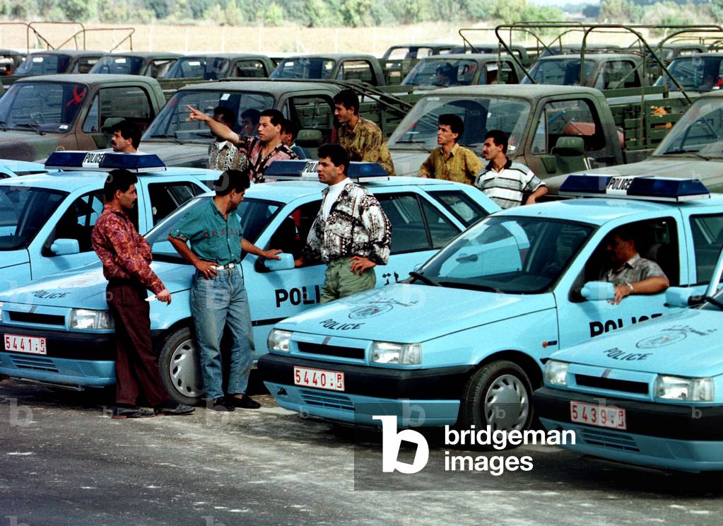 Image of Palestinian police in civilian clothes gather around their ...
