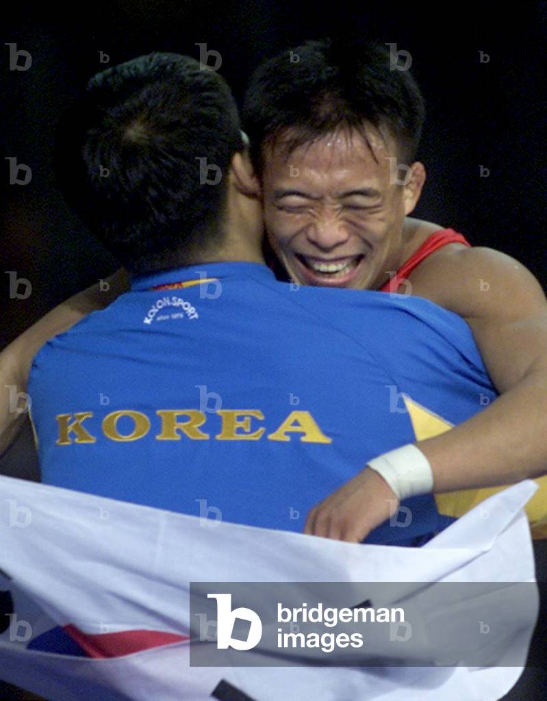 Image of SIM KWON HO OF SOUTH KOREA CELEBRATES IN THE ARMS