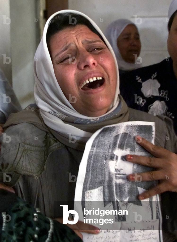 Image of MOTHER OF PALESTINIAN POLICEMAN CRIES DURING HIS FUNERAL IN GAZA,