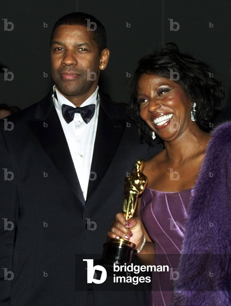 Image of Actor Denzel Washington, poses with his wife Pauletta who holds