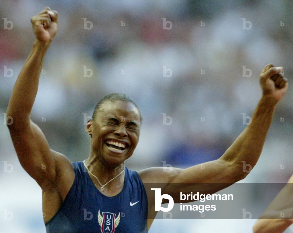 Image of KELLI WHITE OF THE US CELEBRATES WINNING THE WOMEN'S 100