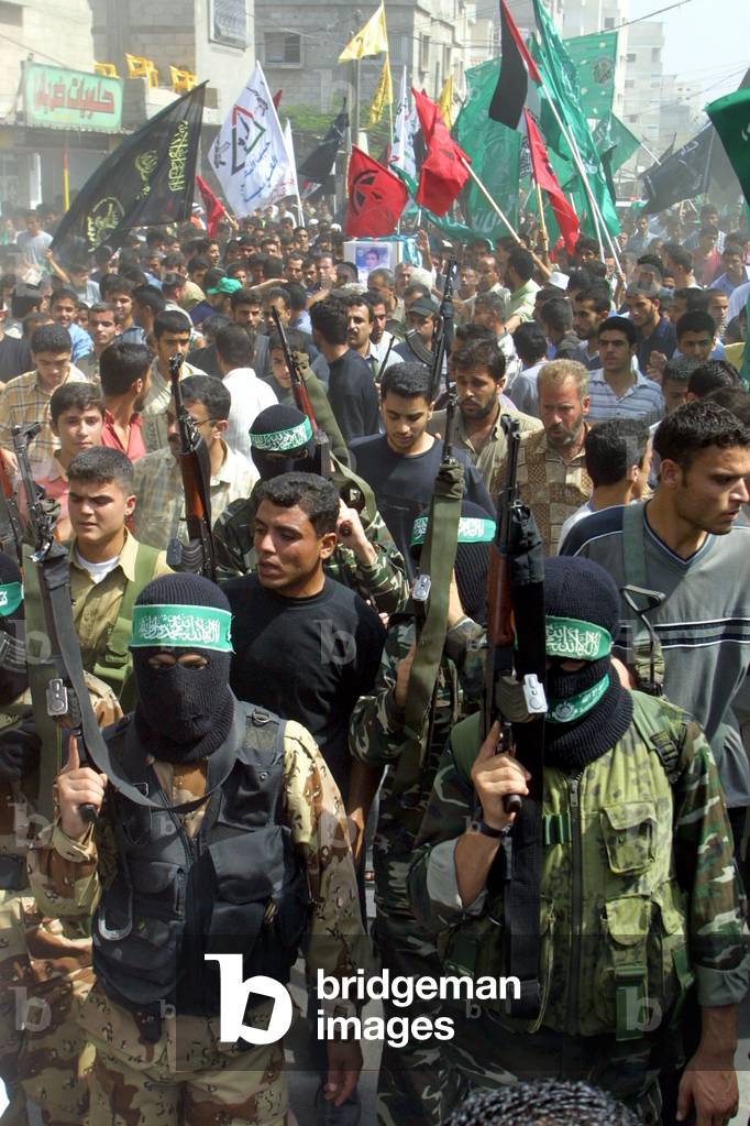 Image of HAMAS GUNMEN MARCH AT THE FUNERAL OF ABDEL AL-RAHEM HAMDAN