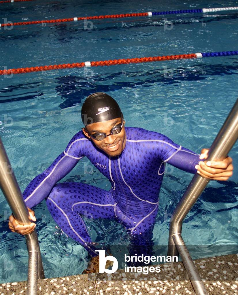 Image of Eric Moussambani of Equatorial Guinea climbs out of the pool