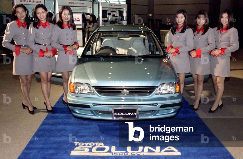 Image of Thai models pose with new Toyota car being displayed at