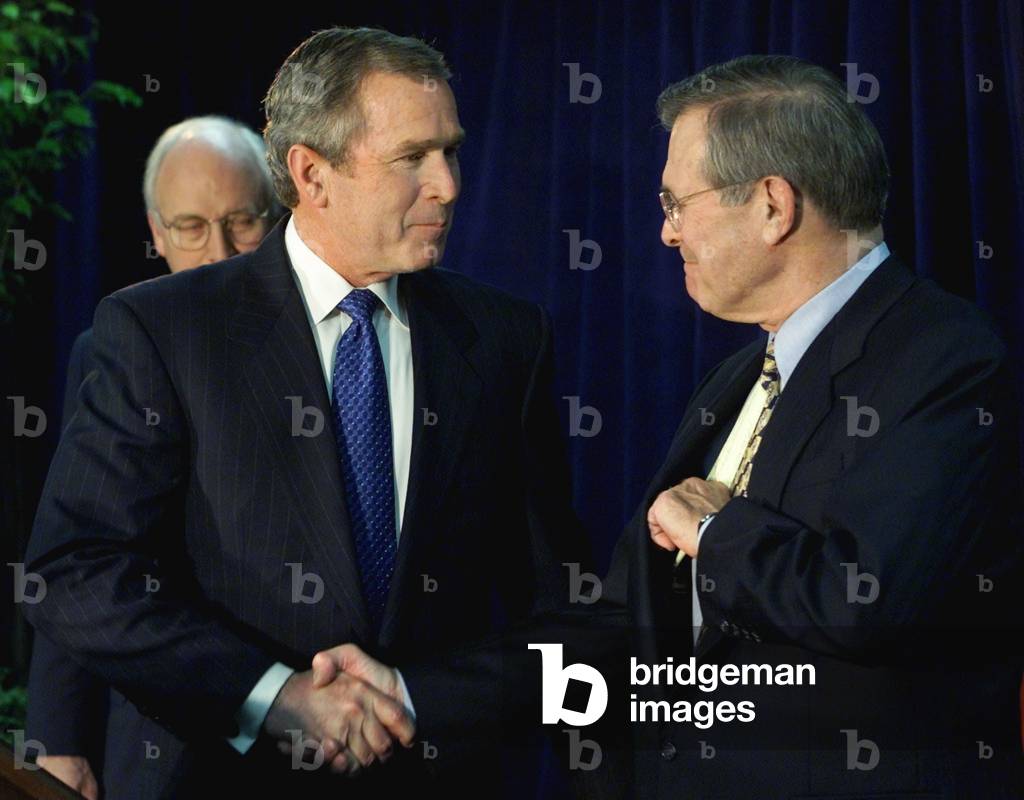Image of PRESIDENT ELECT GEORGE W BUSH SHAKES HANDS WITH DONALD RUMSFELD,