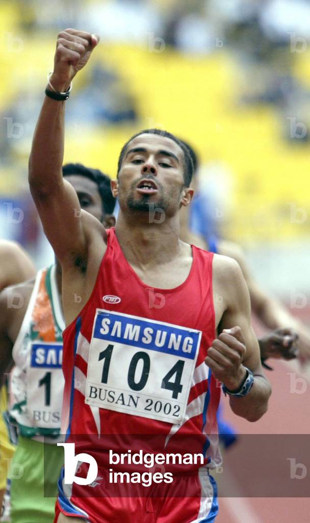 Image of MOHAMED OF BAHRAIN REACTS AS HE CROSSES THE FINISH LINE