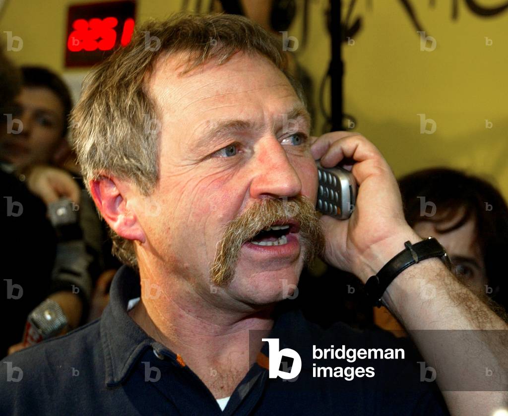 Image of FRENCH FARMER JOSE BOVE USES HIS CELLPHONE AT THE PARIS