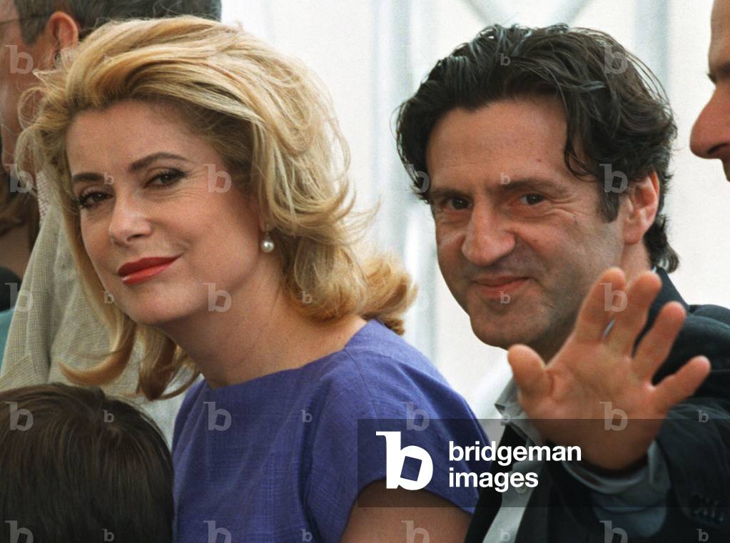 Image of French actor Daniel Auteuil (R) waves as he stands alongside
