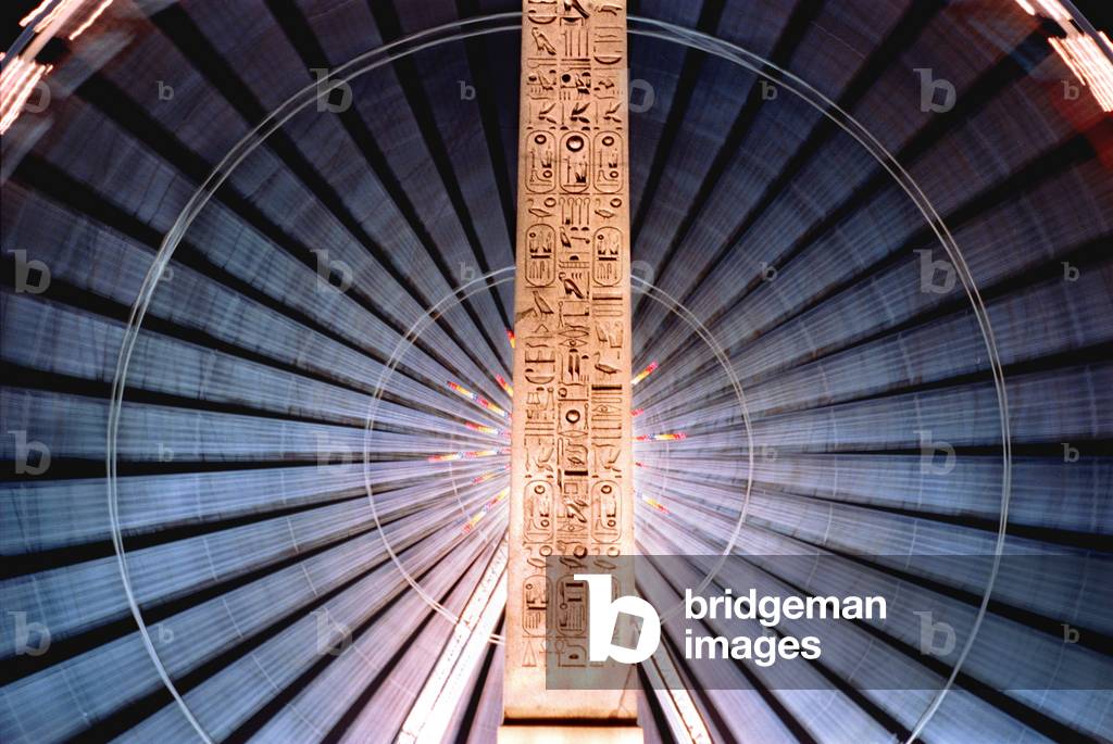 Image of A 50-metre high ferris wheel turns behind the Louqsor obelisk