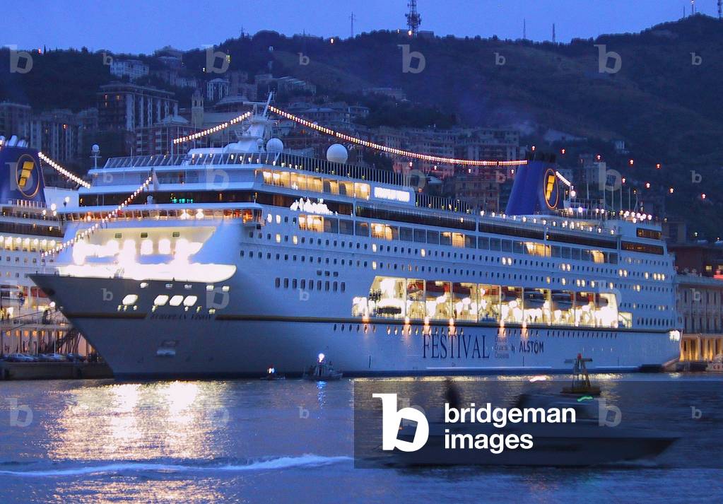 Image of A PATROL BOAT SPEEDS PASSES THE LUXURY LINER THE EUROPEAN