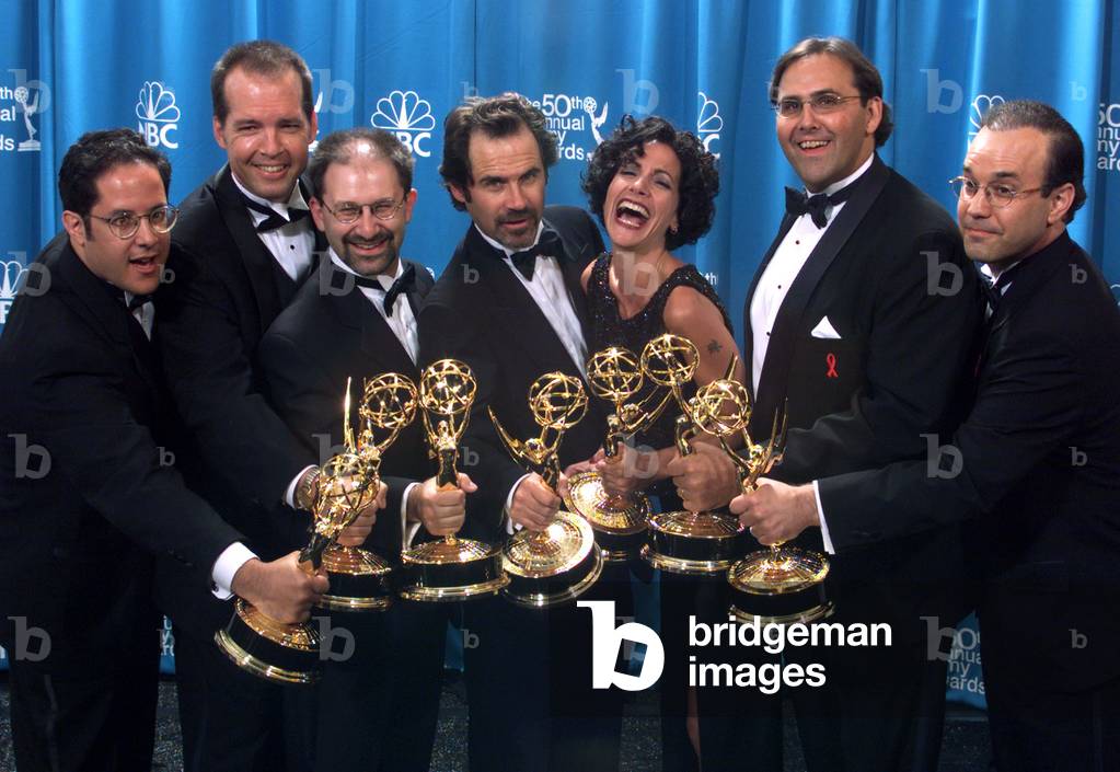 Image of Actor/comedian Dennis Miller (C) with members of his writing crew,