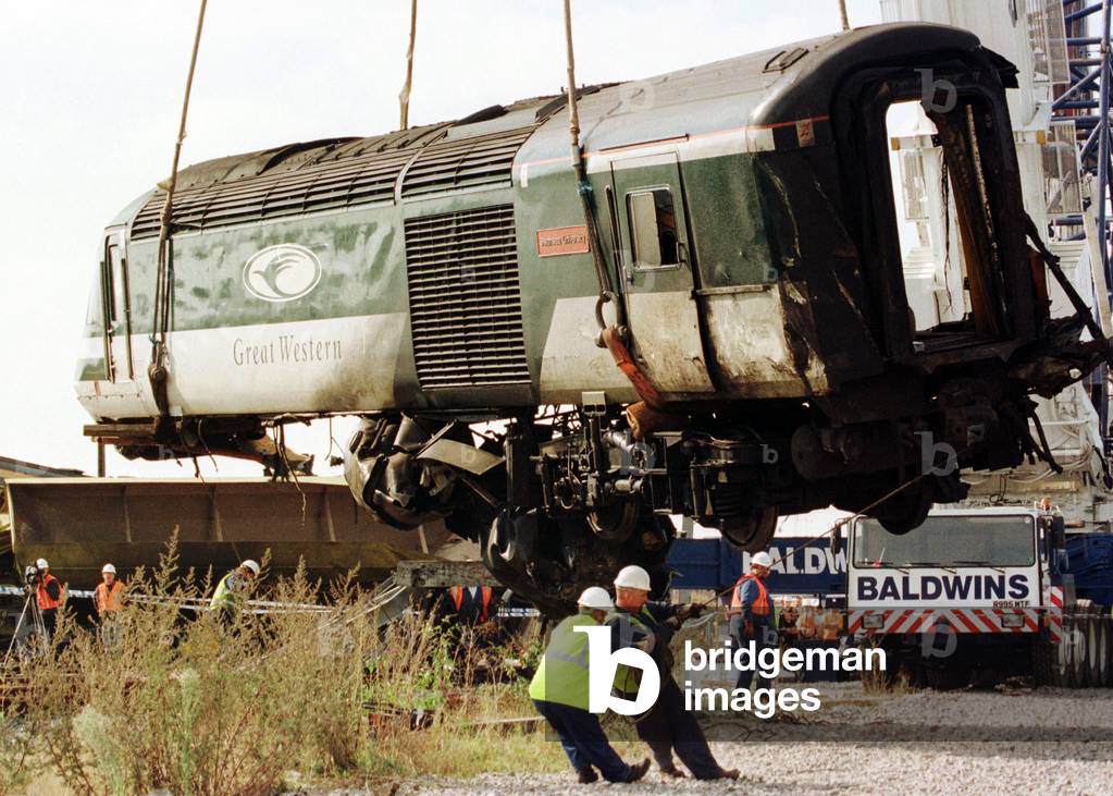 Image of Engineers move the front engine of the crashed express train