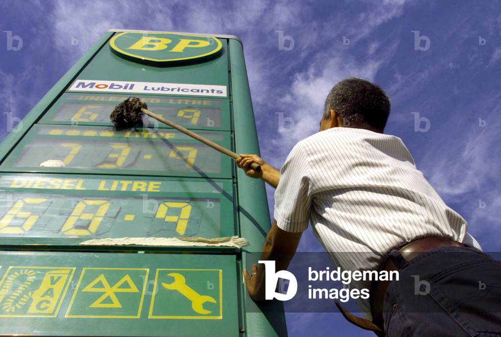 Image of A worker cleans the sign outside a British Petroleum (BP)