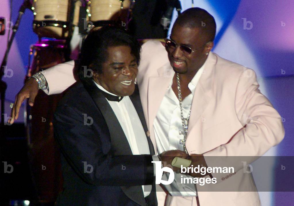 Image of Soul legend James Brown (L) gets a hug from rapper